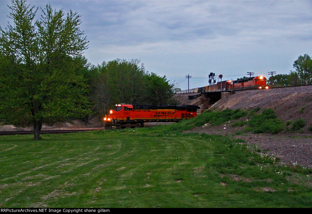 BNSF 7251 Heads Wb with stacks while a local returns above.